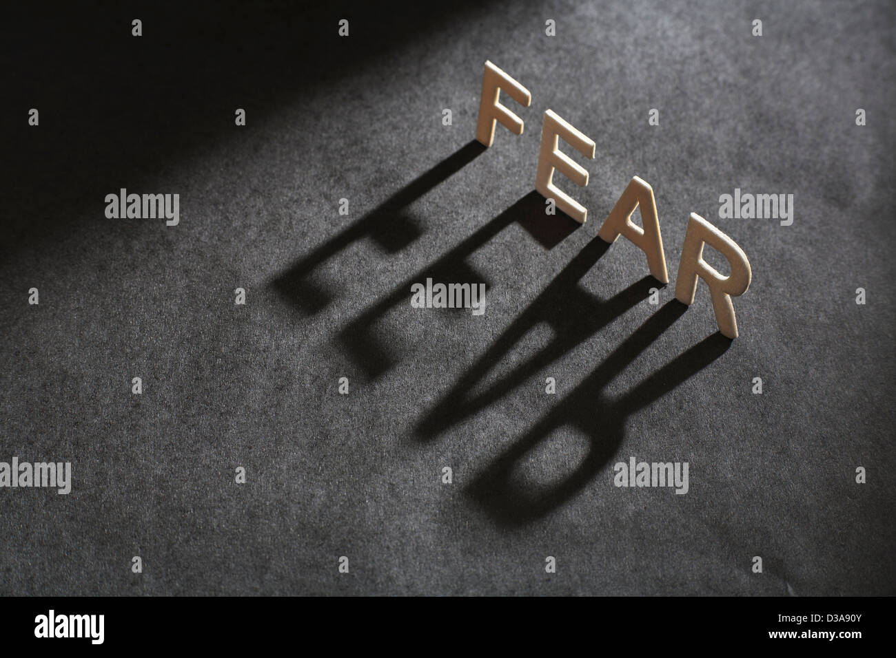 Letters spelling ?fear casting shadow Stock Photo - Alamy