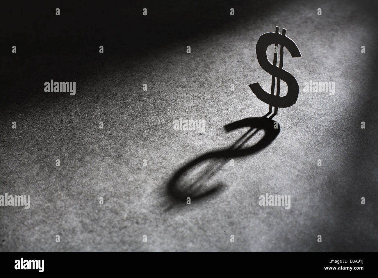 Metal dollar sign casting shadow Stock Photo - Alamy