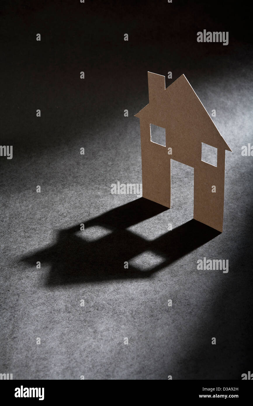 Cardboard house shape casting shadow Stock Photo - Alamy