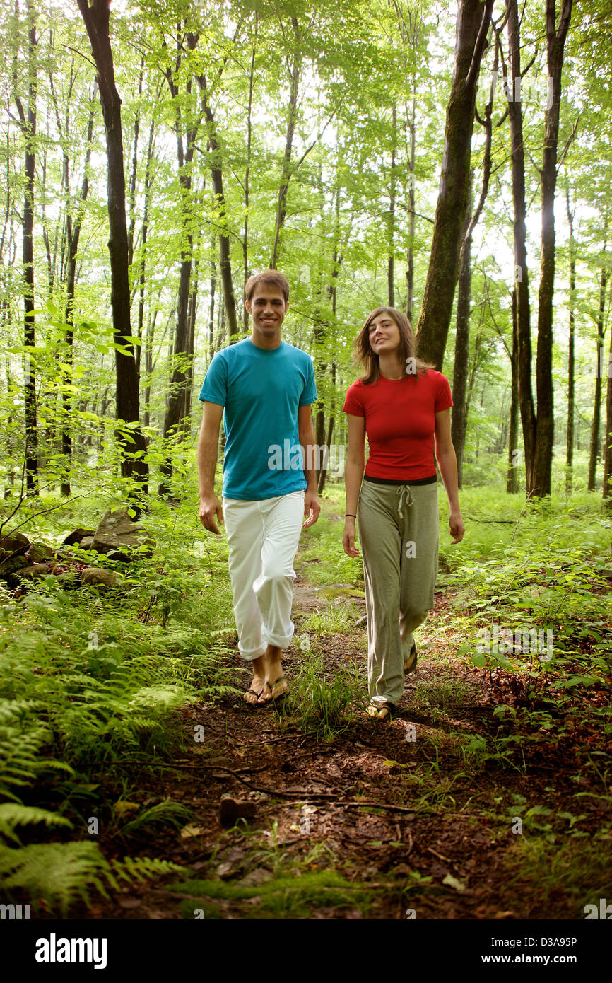 Couple walking in forest Stock Photo - Alamy