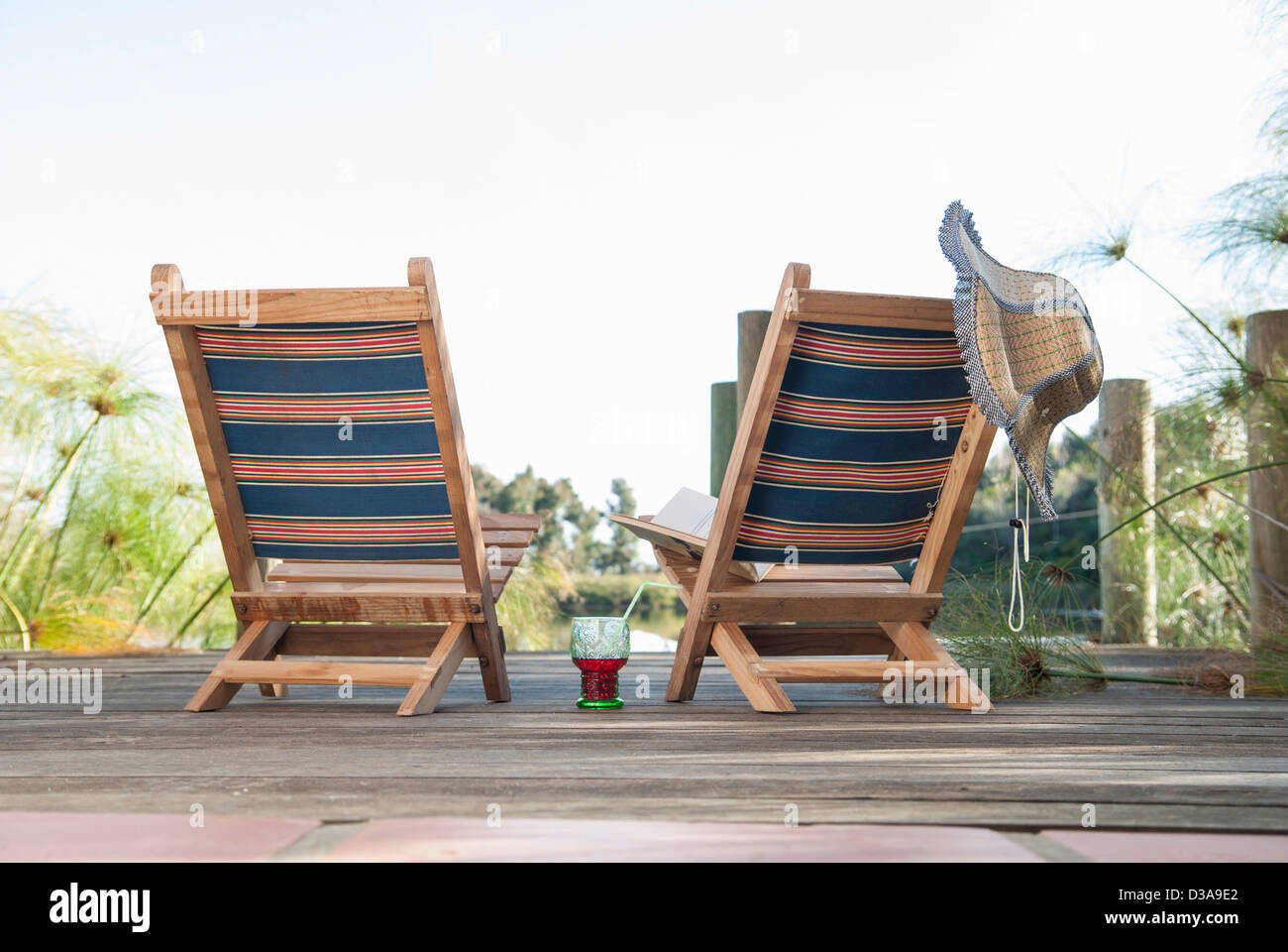 Empty lawn chairs on deck Stock Photo - Alamy