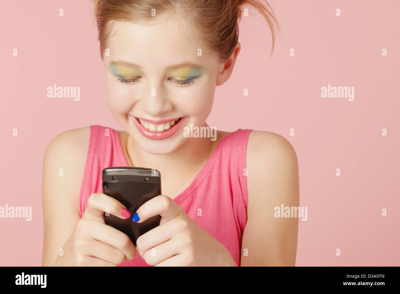 Girl in colorful makeup using cell phone Stock Photo - Alamy
