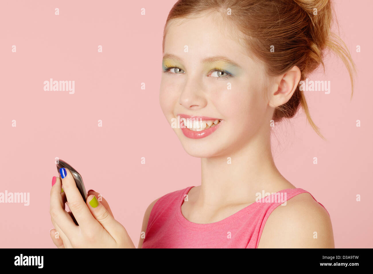 Girl in colorful makeup using cell phone Stock Photo - Alamy