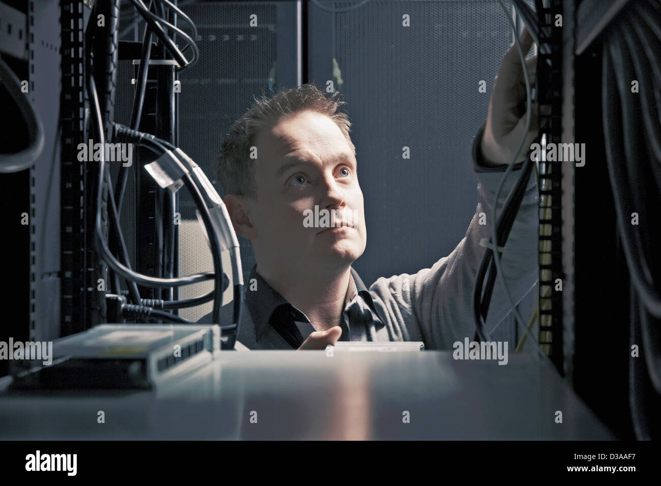 Man working in server room Stock Photo - Alamy