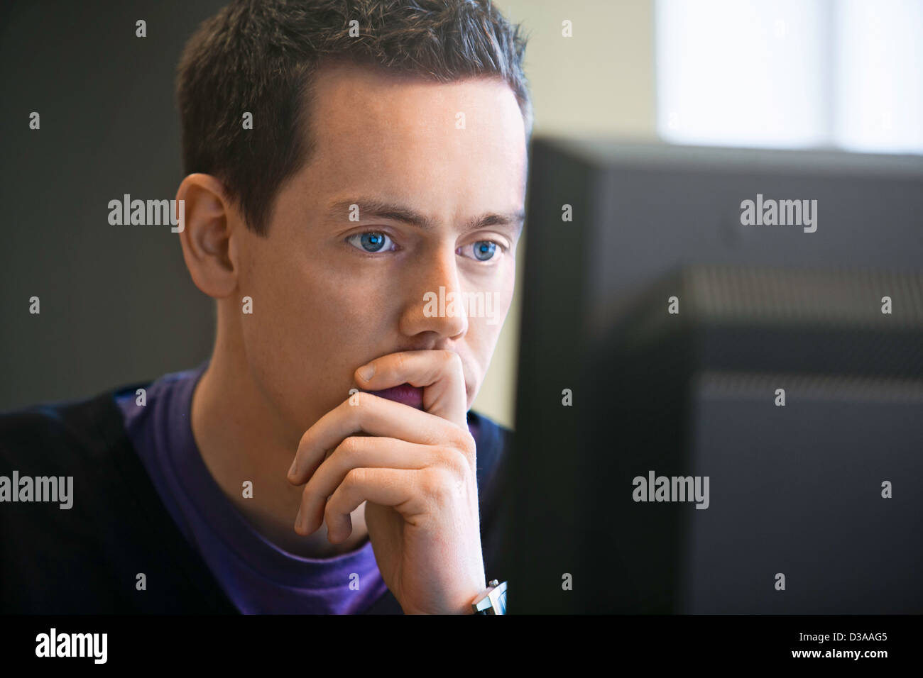 Man using computer at desk Stock Photo - Alamy