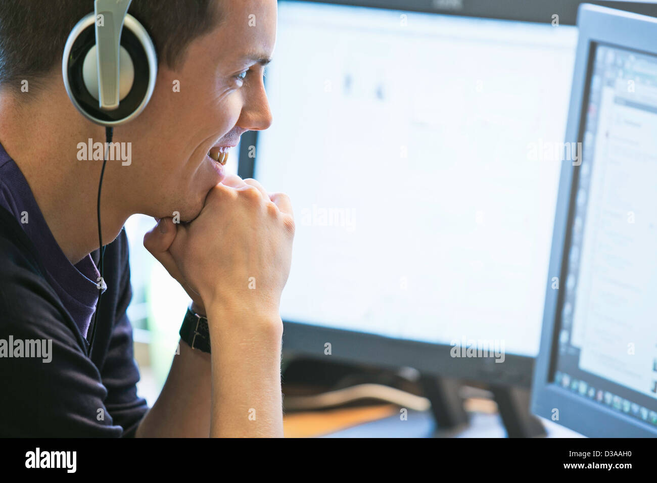 Man using computers at desk Stock Photo - Alamy