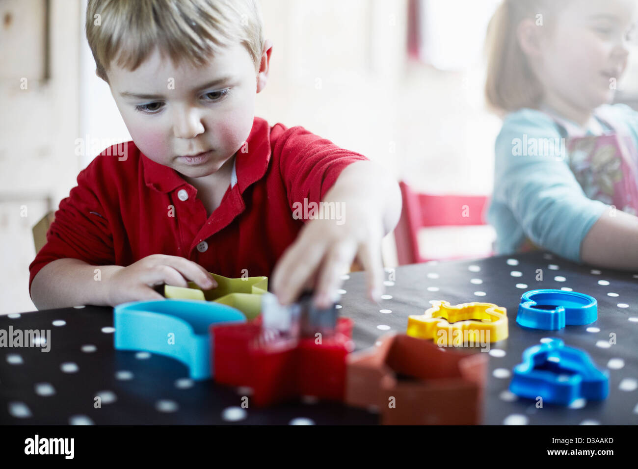 Children playing with shapes on table Stock Photo - Alamy