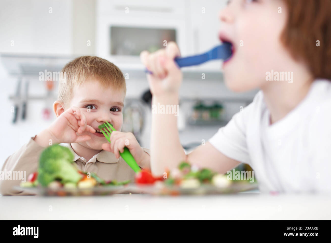 Children eating together at table Stock Photo - Alamy