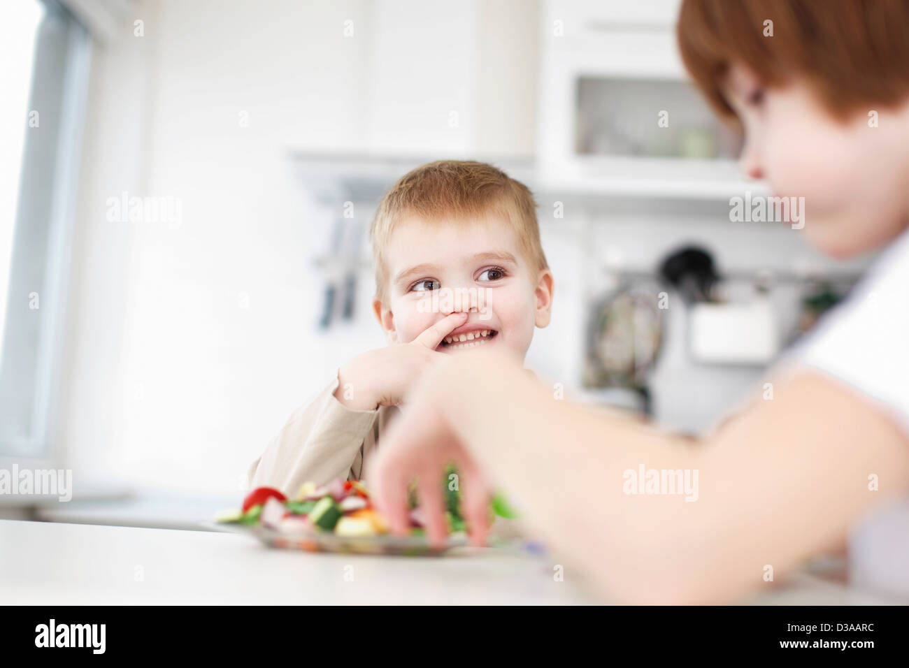 Children eating together at table Stock Photo - Alamy