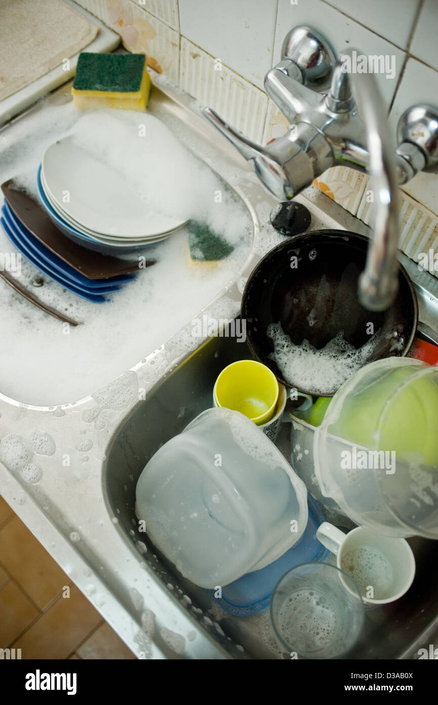 Dirty dishes in kitchen sink Stock Photo - Alamy