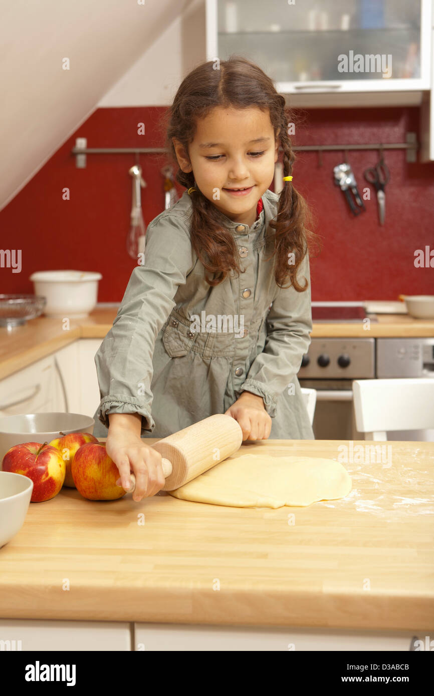 Girl rolling pastry dough in kitchen Stock Photo - Alamy