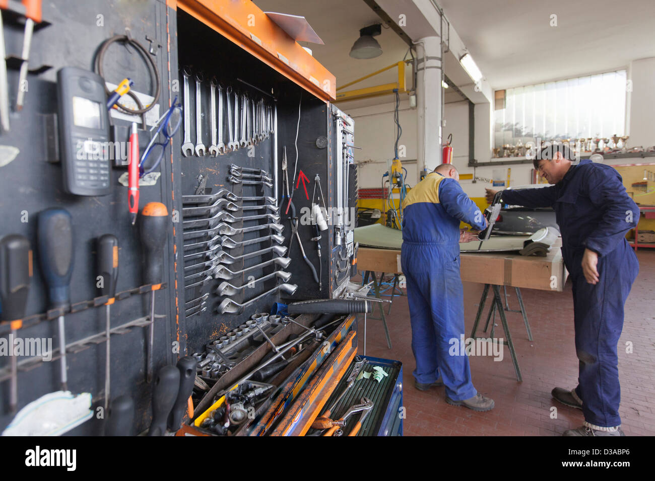 Mechanics working in garage Stock Photo - Alamy
