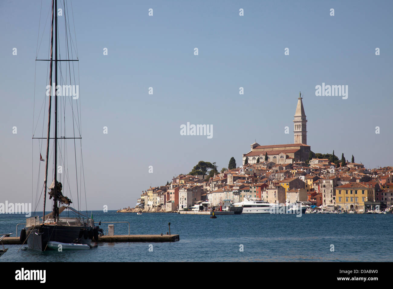Tower over village and waterfront Stock Photo - Alamy