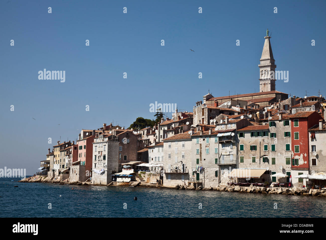 Tower over village and waterfront Stock Photo - Alamy
