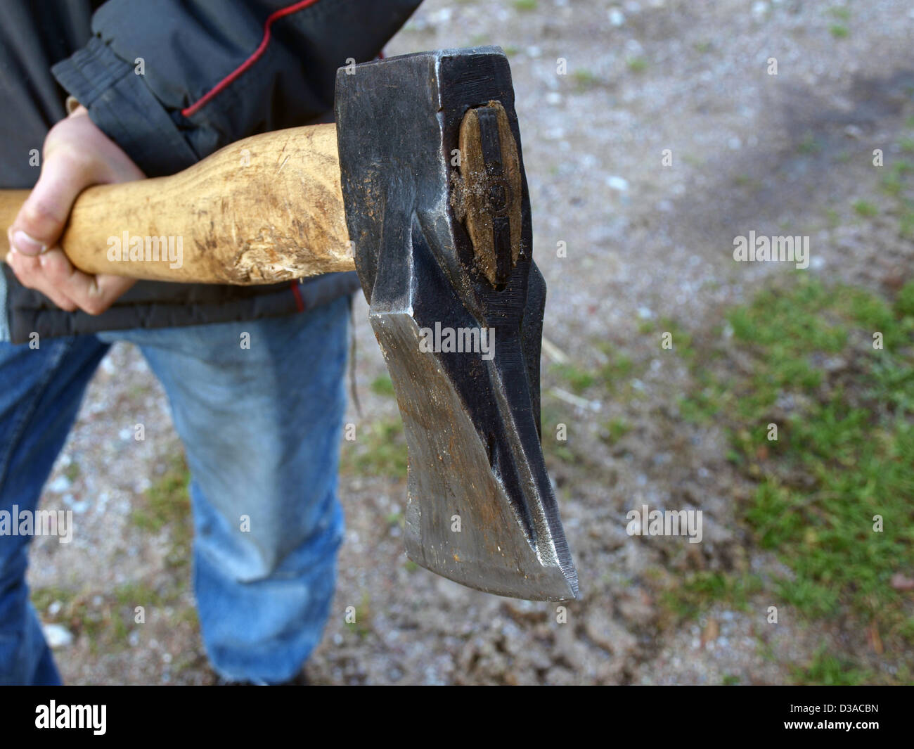 Young man partly visible holding special cutting ax Stock Photo - Alamy