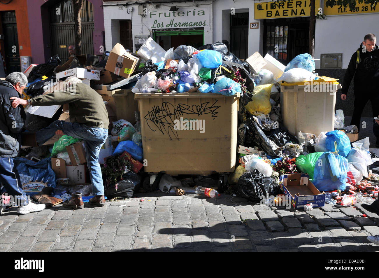 rubbish piling up in street, men clearing street of bin bags and ...