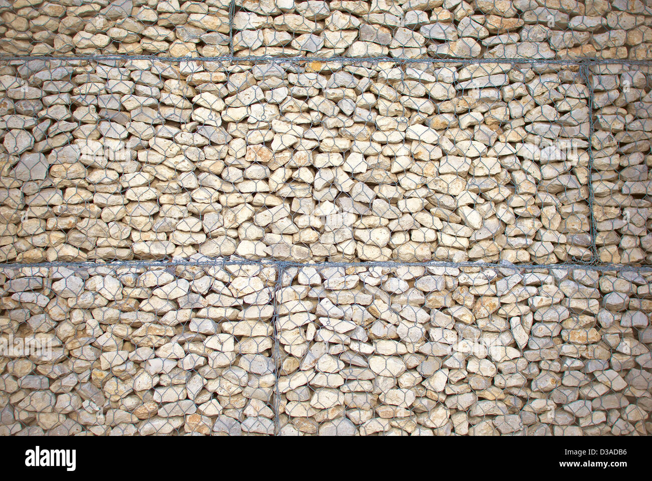 Stone wall with wire mesh for background Stock Photo - Alamy