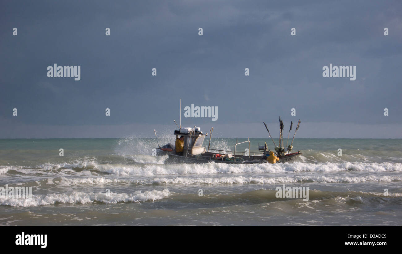 Fishing boat landing in rough surf, Normandy, France Stock Photo - Alamy