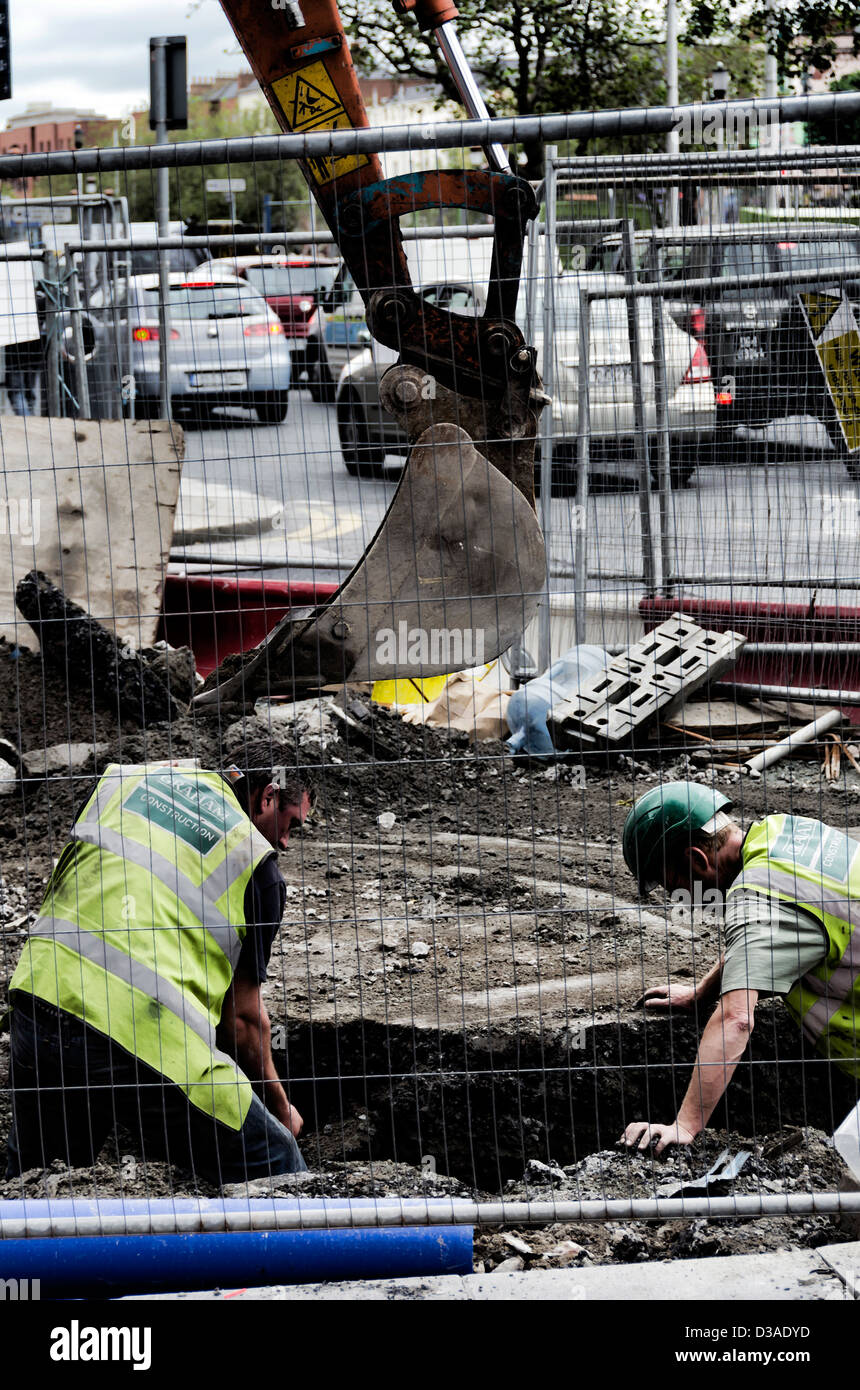 Road worker digging to install cable in Dublin City, Ireland Stock ...