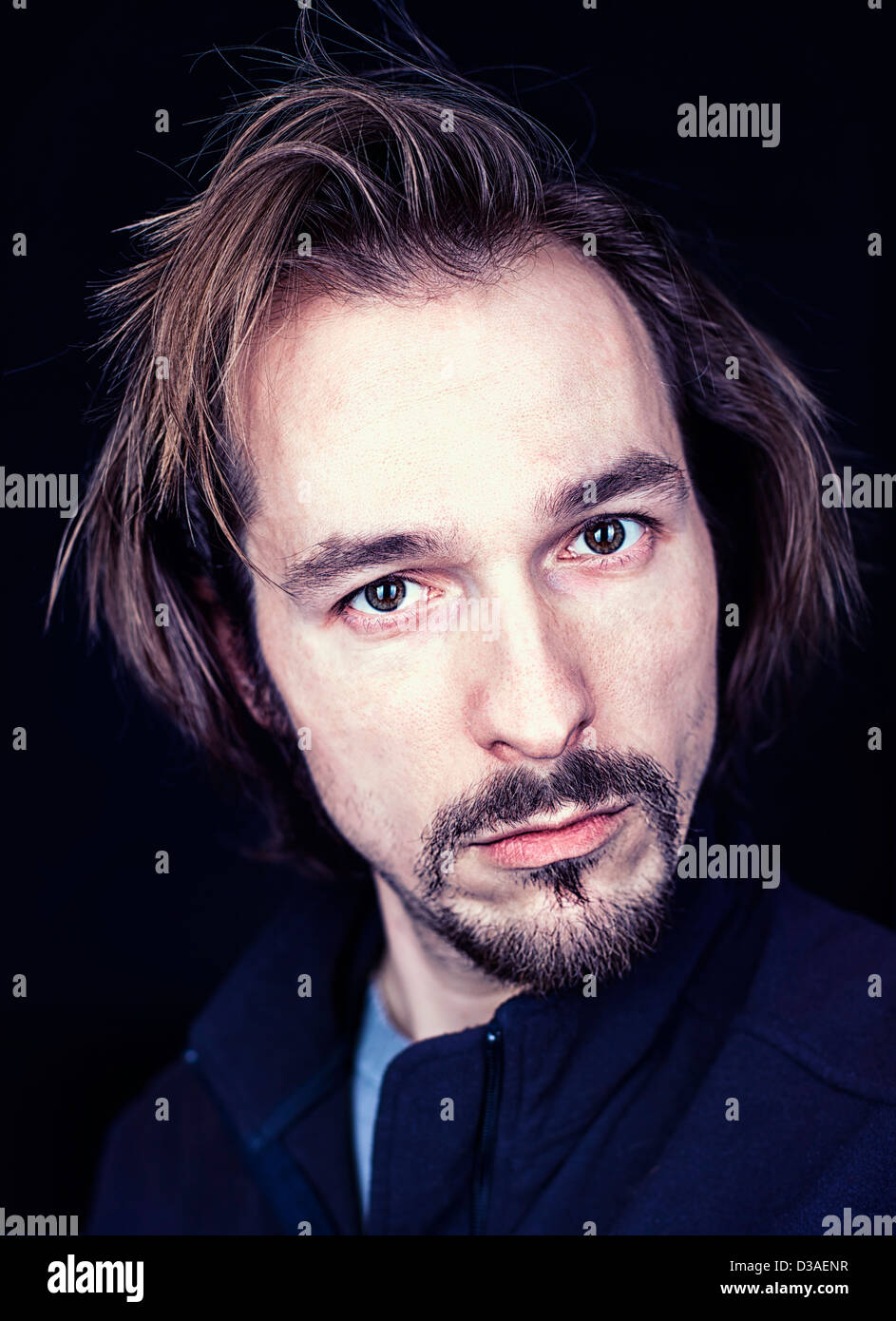 Very Serious looking man with dark background Stock Photo - Alamy