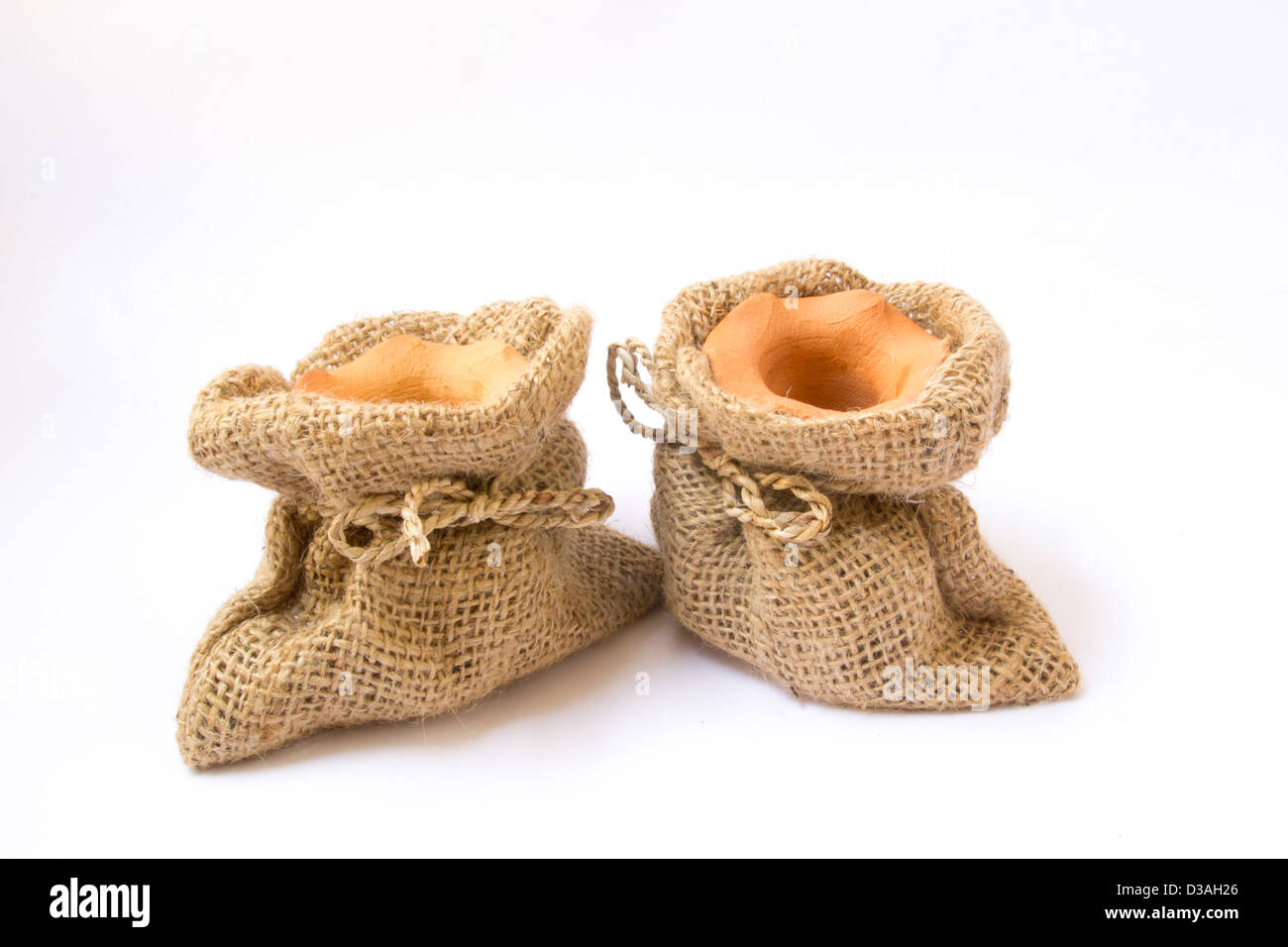 Clay pots in burlap sack isolated on white background Stock Photo - Alamy