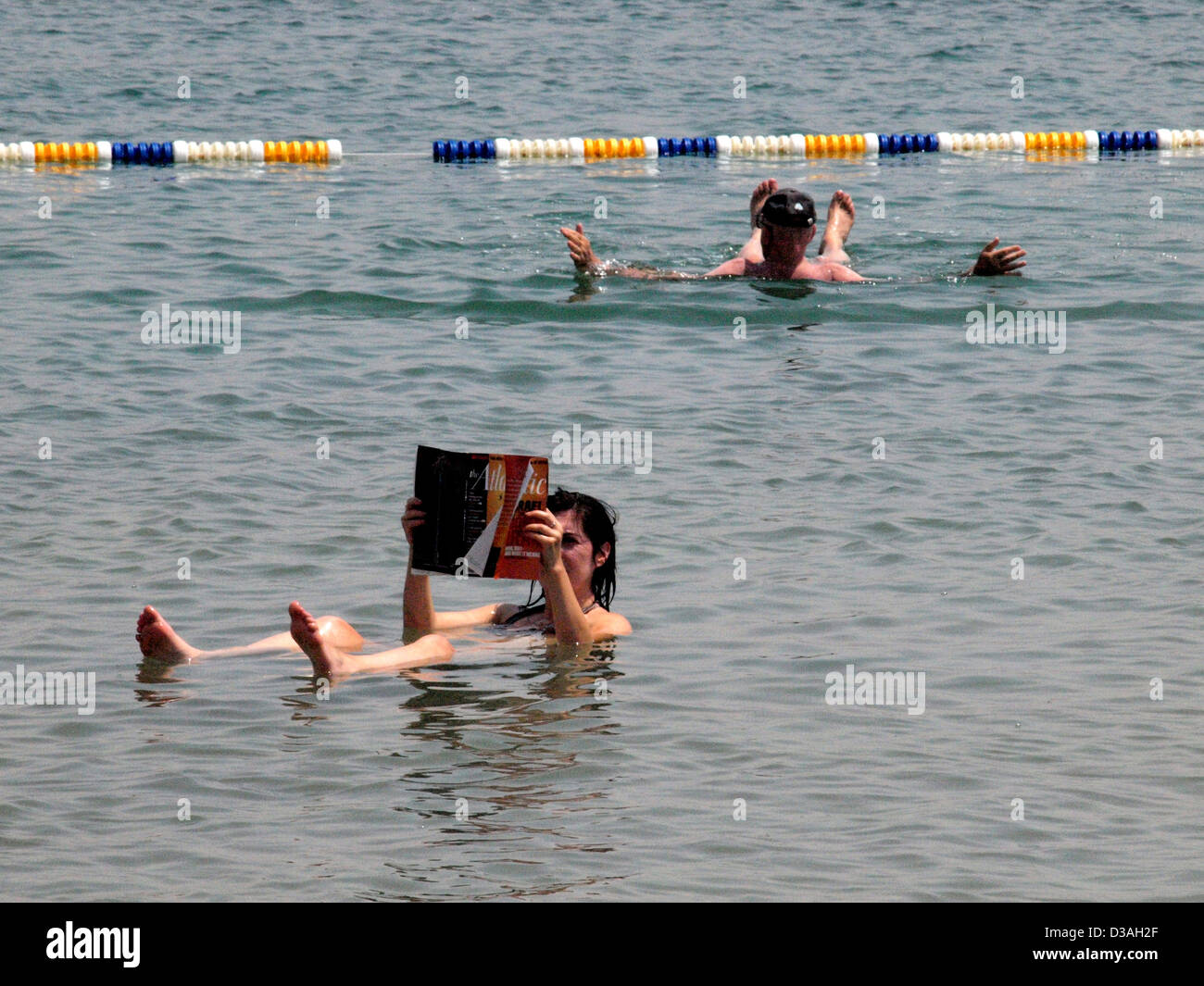 Woman reading magazine while floating in dead sea, Israel Stock Photo ...