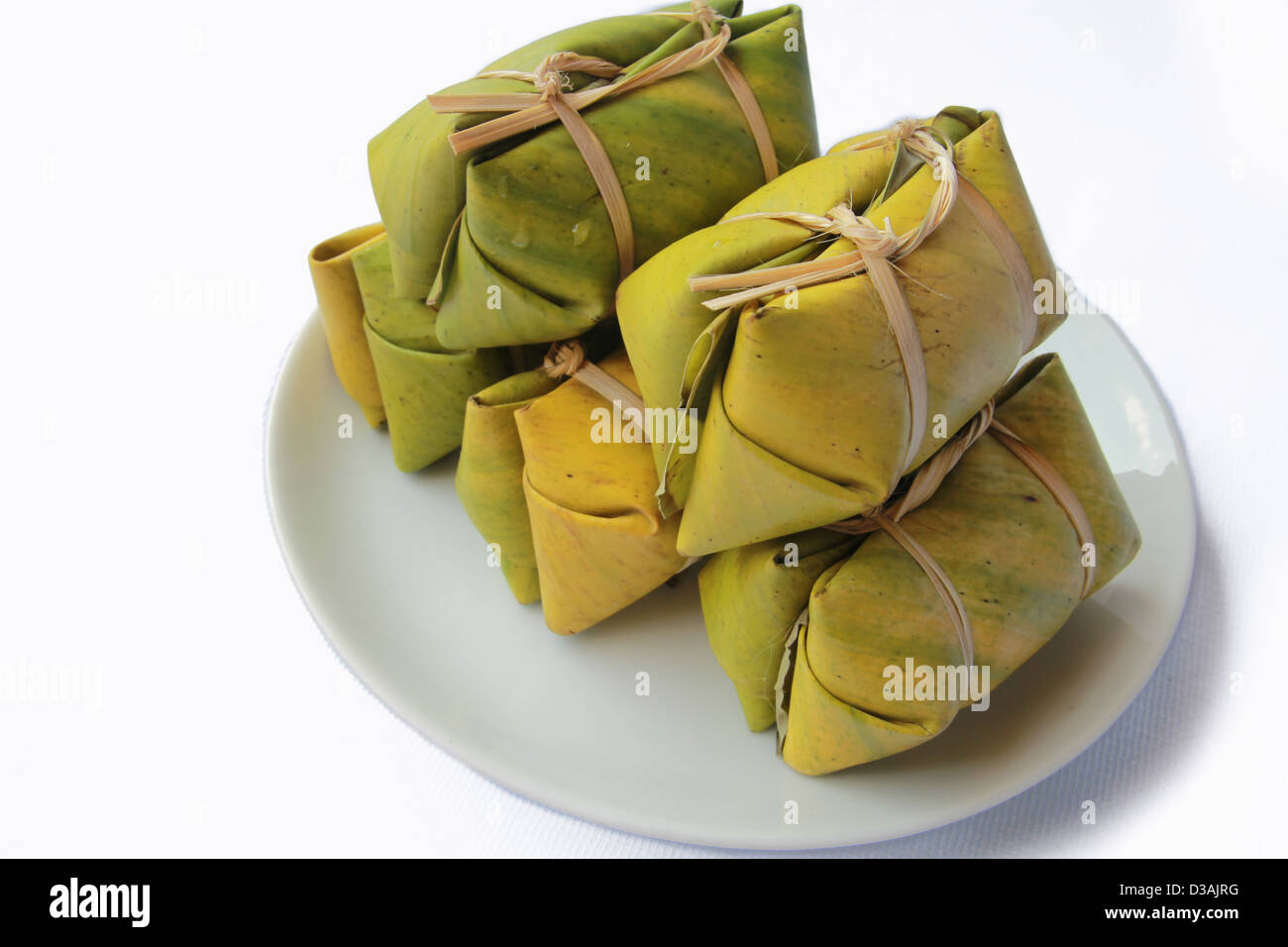 Thai style dessert on Plate, made from banana and glutinous rice, wrap ...