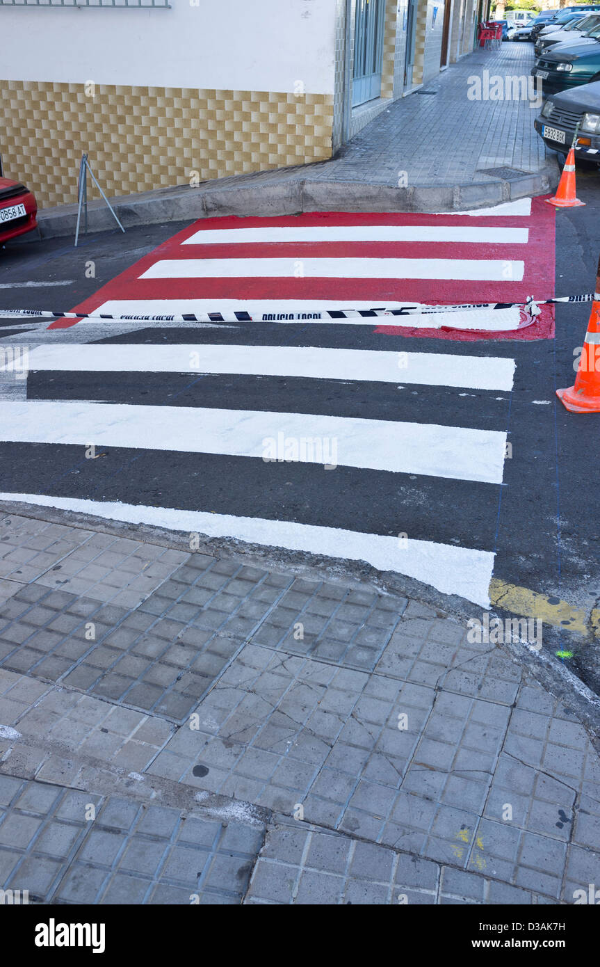 New pedestrian crossing points being painted in red and white Stock ...