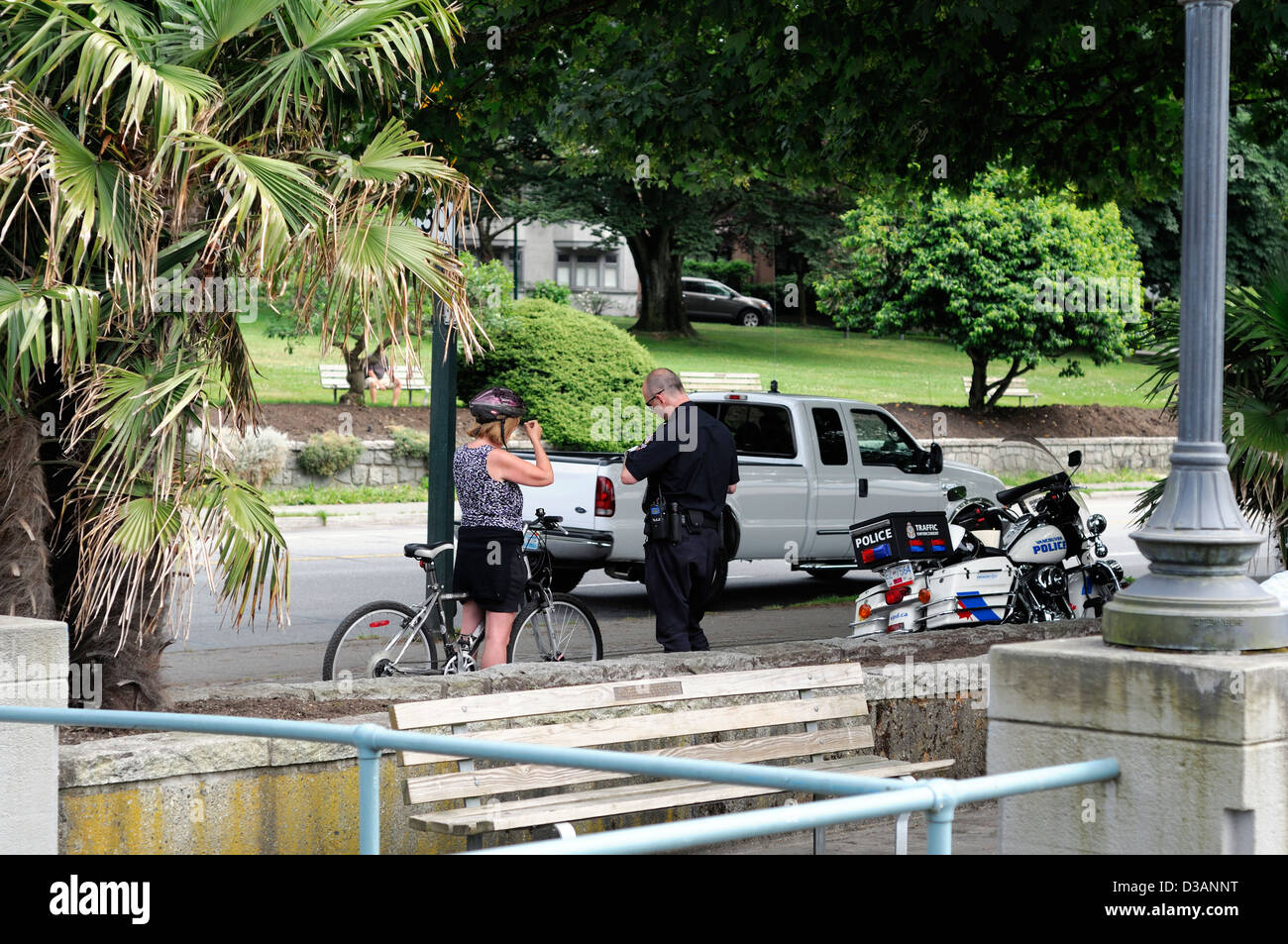 woman cyclist receiving getting ticket fine police law enforce enforcer ...