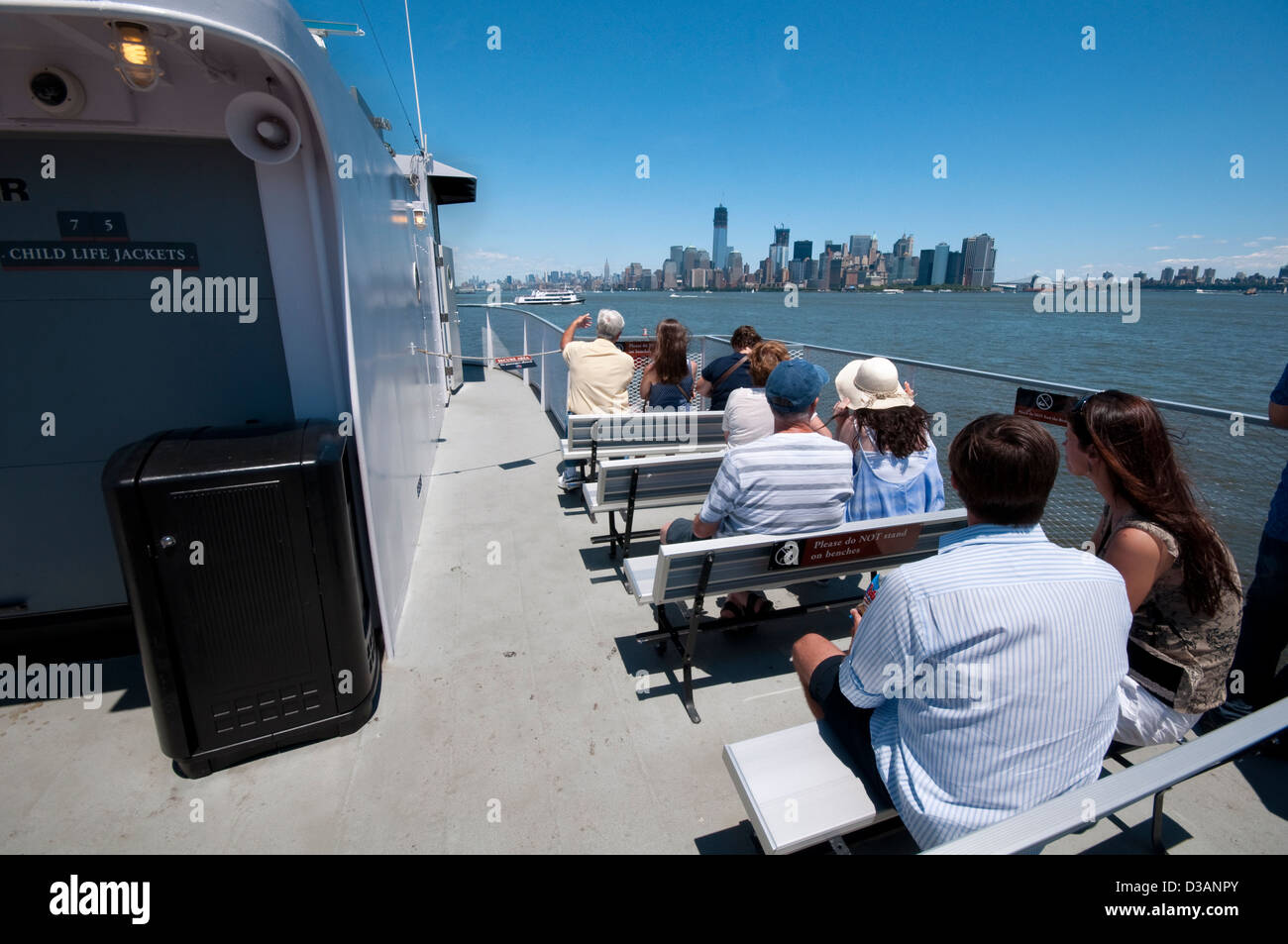 USA, New York, Tourists on Circle Line Tour Boat, Manhattan Skyline ...