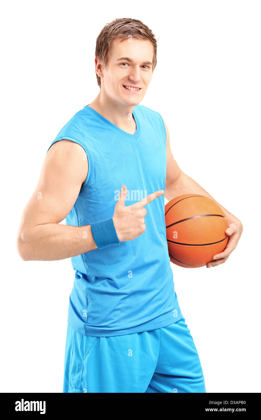 A smiling basketball player holding a ball and gesturing isolated on ...