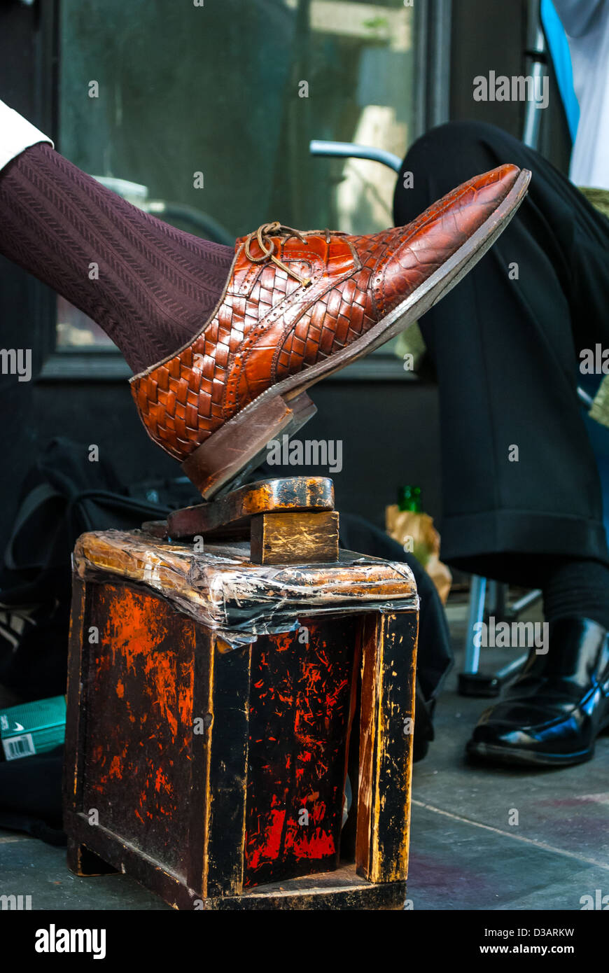 Photograph of a Shoeshiners own shoe on his shining stand waiting for ...