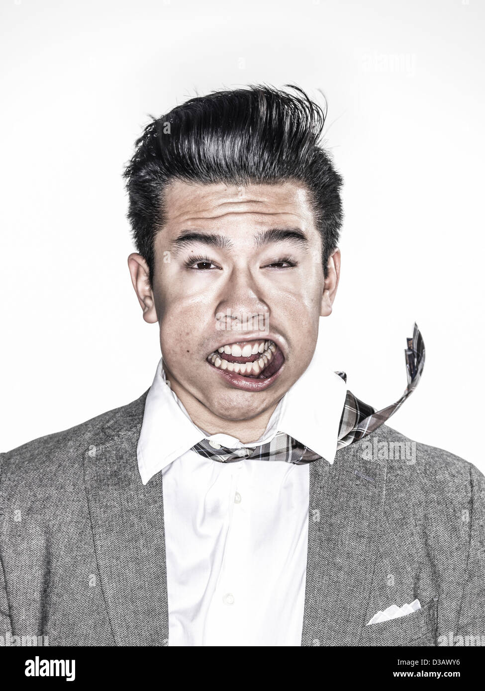 Businessman making face in wind Stock Photo - Alamy