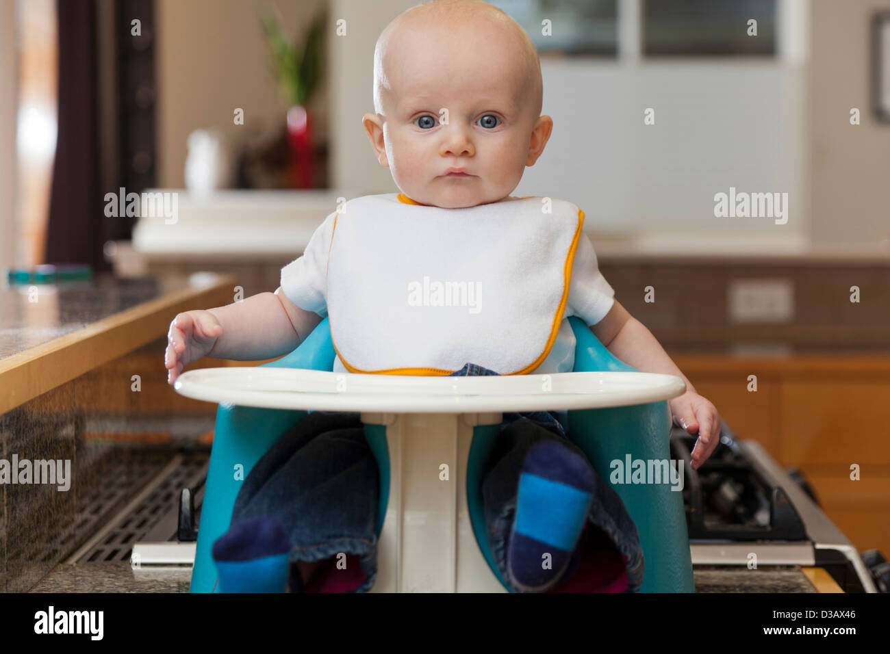 Caucasian baby sitting in high chair Stock Photo - Alamy