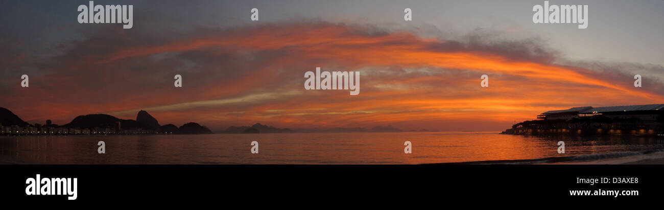 Copacabana Beach under the first rays of sun. At left, Sugarloaf. At ...