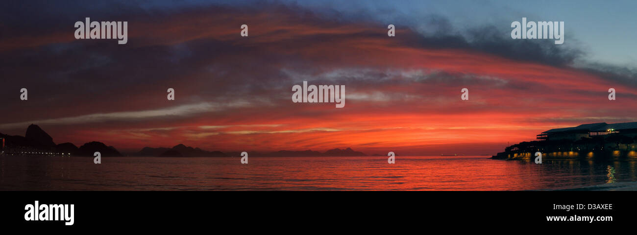 Copacabana Beach under the first rays of sun. At left, Sugarloaf. At ...