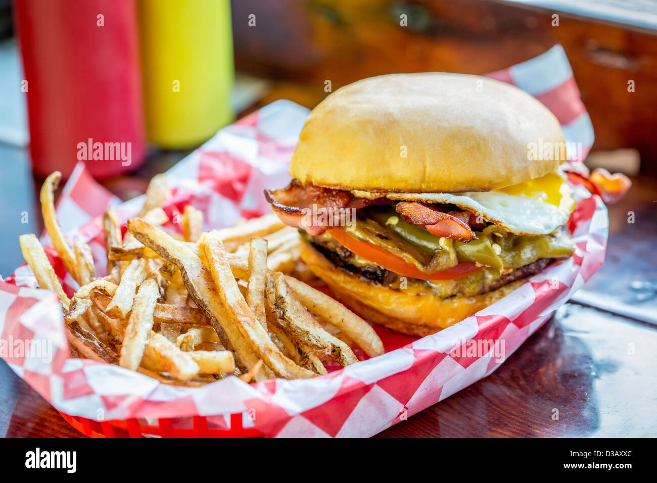 Basket of french fries with cheeseburger and egg Stock Photo - Alamy