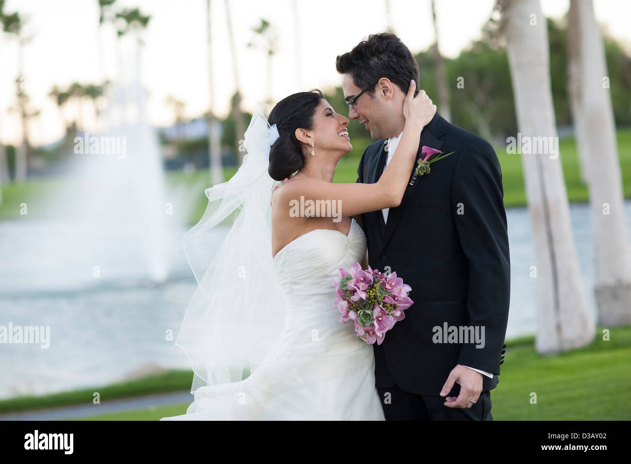 Newlywed couple smiling on golf course Stock Photo - Alamy