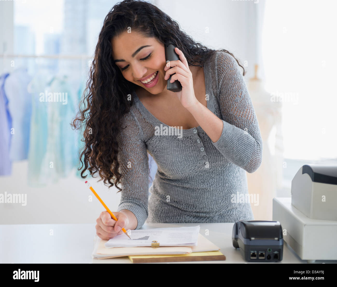 Hispanic woman working in laundromat Stock Photo - Alamy
