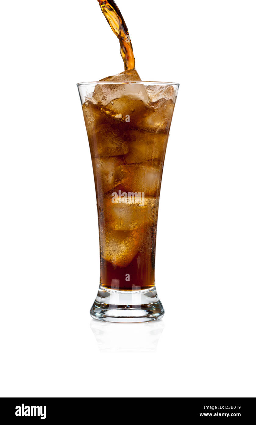 Pouring soda cola in a glass with ice isolated on white background ...