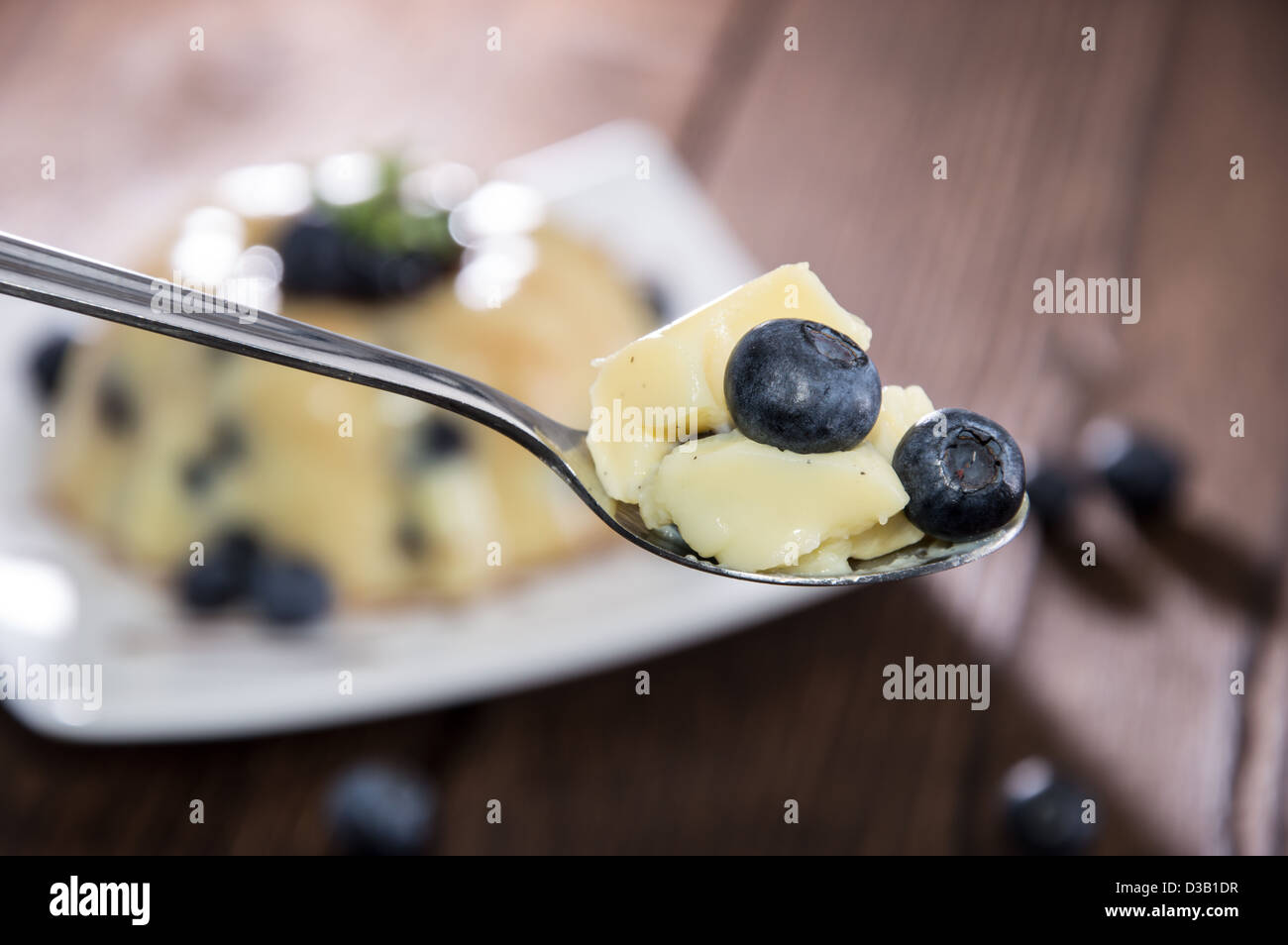 Spoon with Pudding and Blueberries and blurred portion in the ...