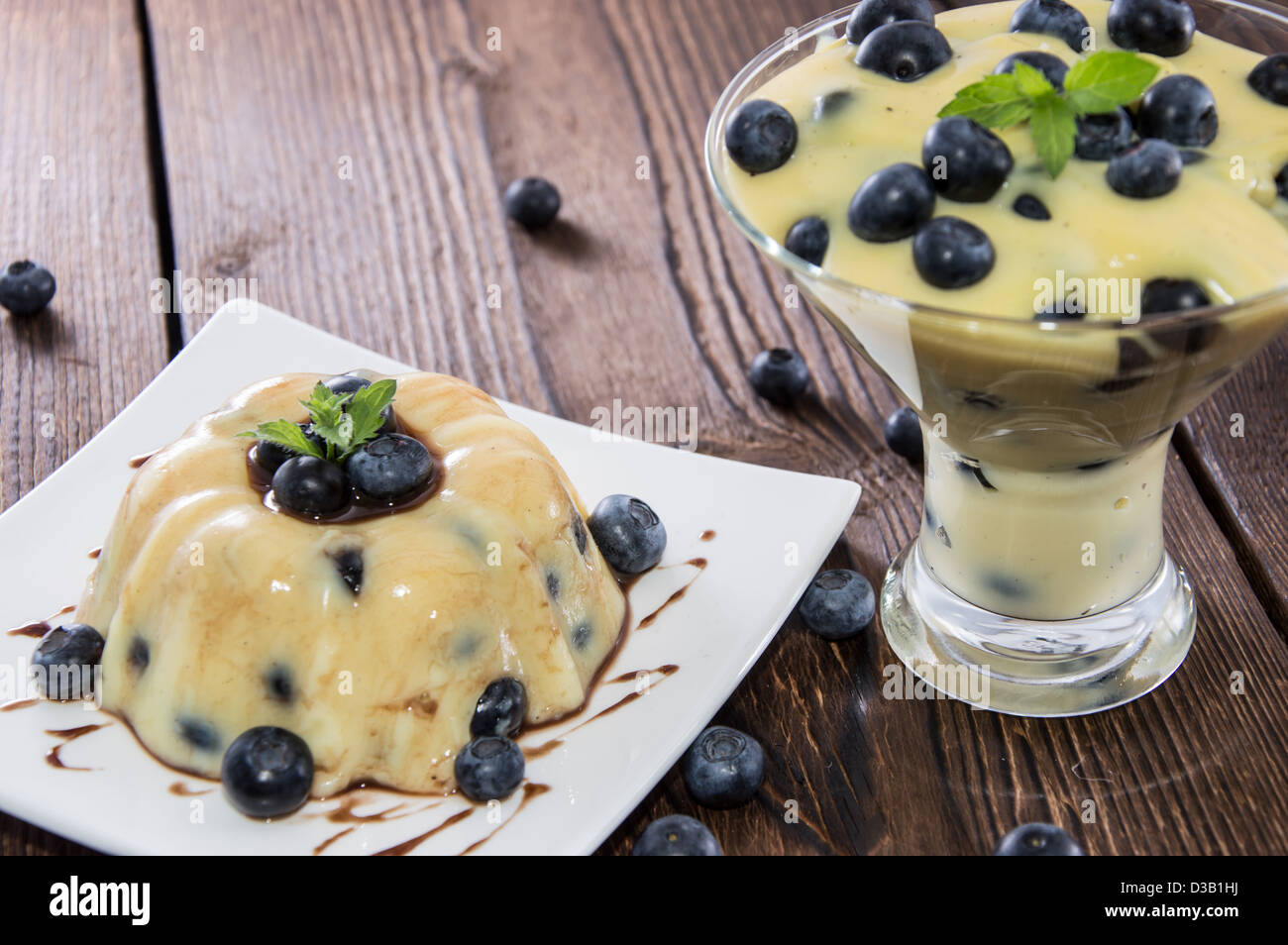 Portion of Blueberry Pudding on wooden background Stock Photo - Alamy