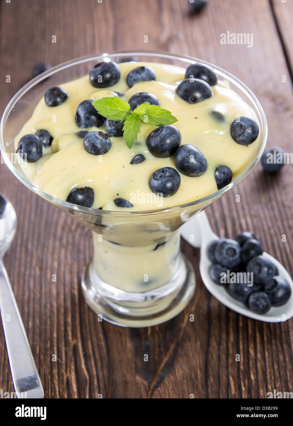 Portion of Blueberry Pudding on wooden background Stock Photo - Alamy