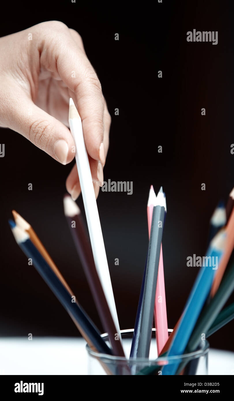 Human hand selecting colored pencil. Vertical photo Stock Photo - Alamy