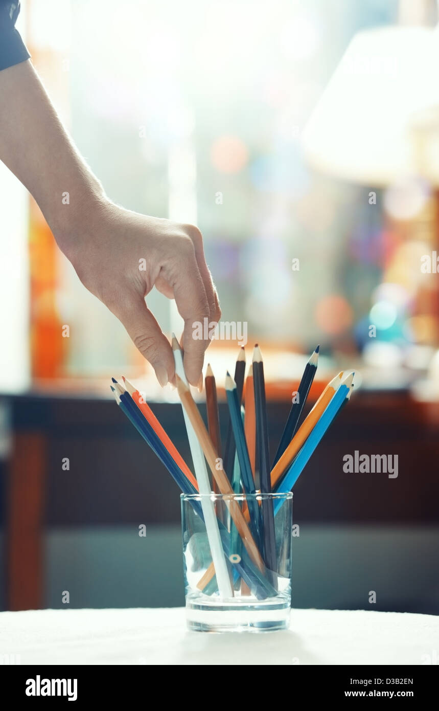 Human hand taking taking pencils Stock Photo - Alamy