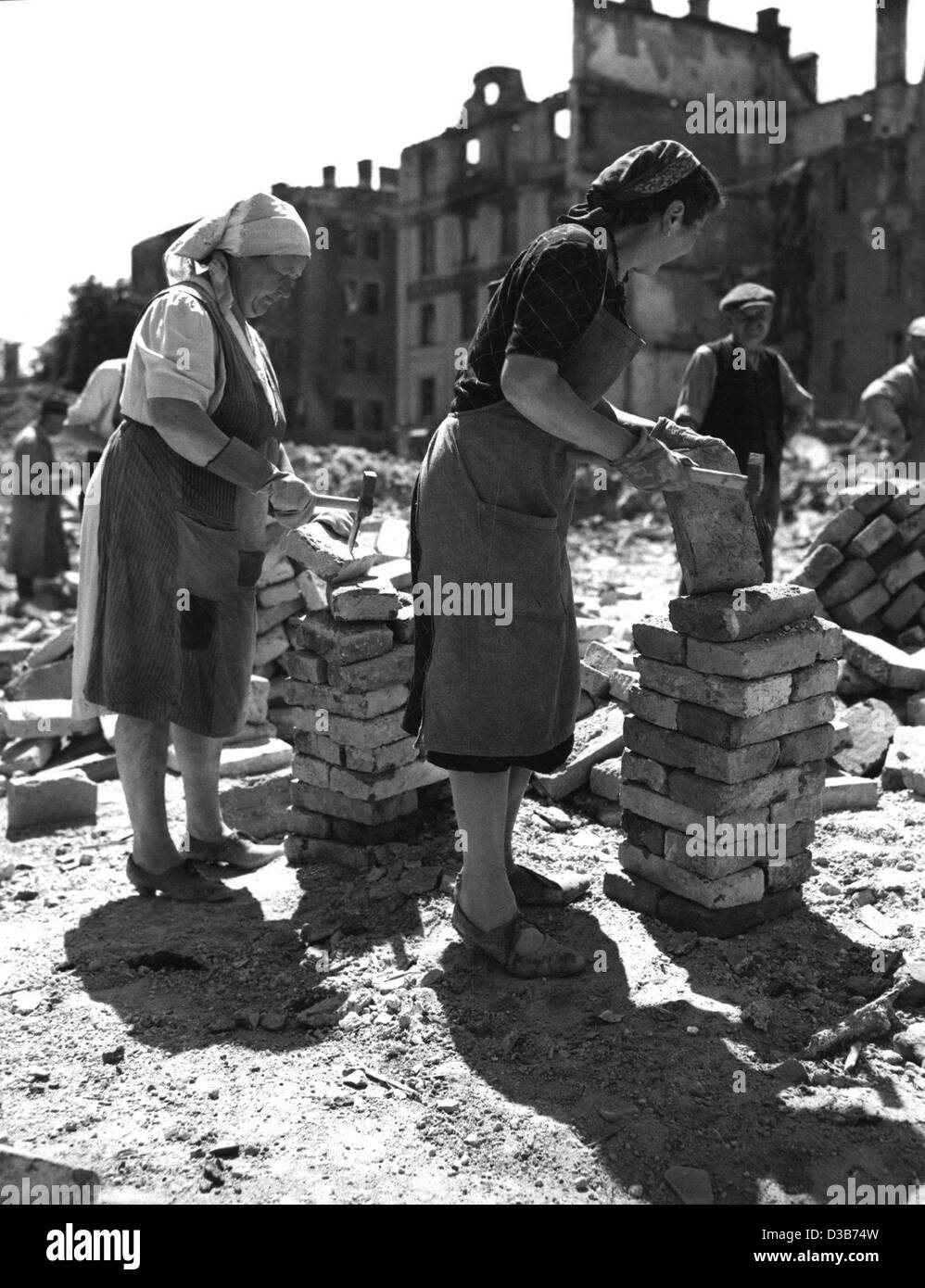 (dpa files) - So-called 'Truemmerfrauen' (rubble-women) clean up bricks ...