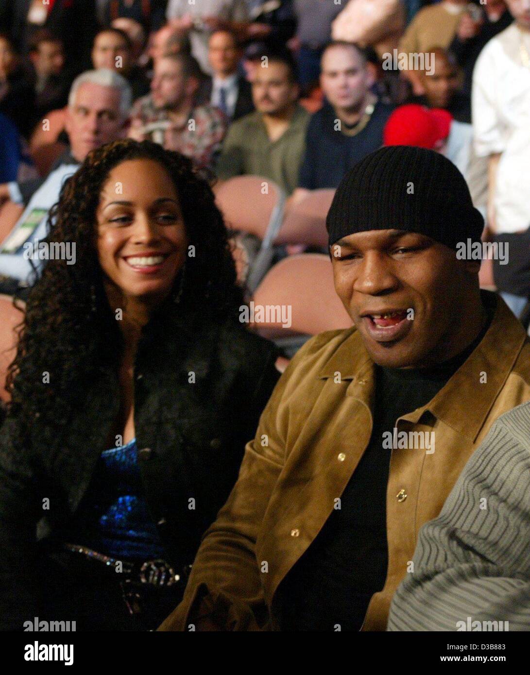 The US boxer Mike Tyson and an unknown woman observe the WBO fight of ...