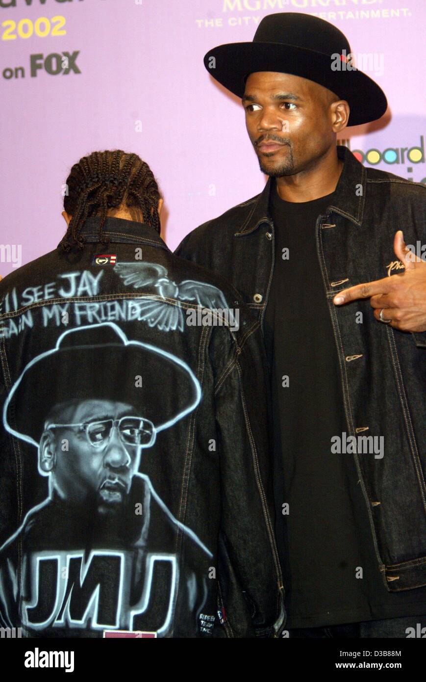 A member of the rap group "Run - DMC"points to graffiti on the jacket ...