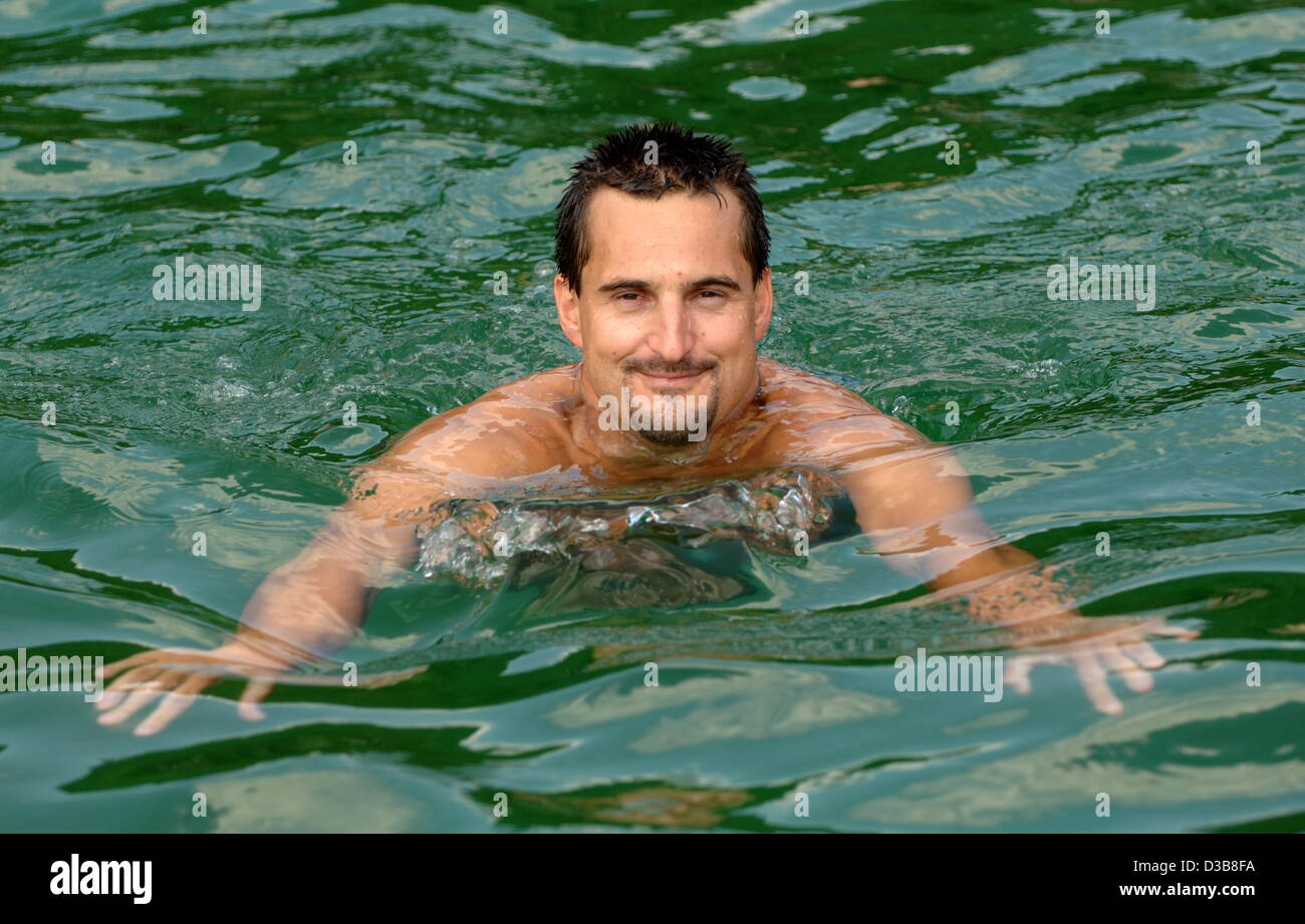 (dpa) - German luger pro Georg Hackl swims in natural swimming pool in ...