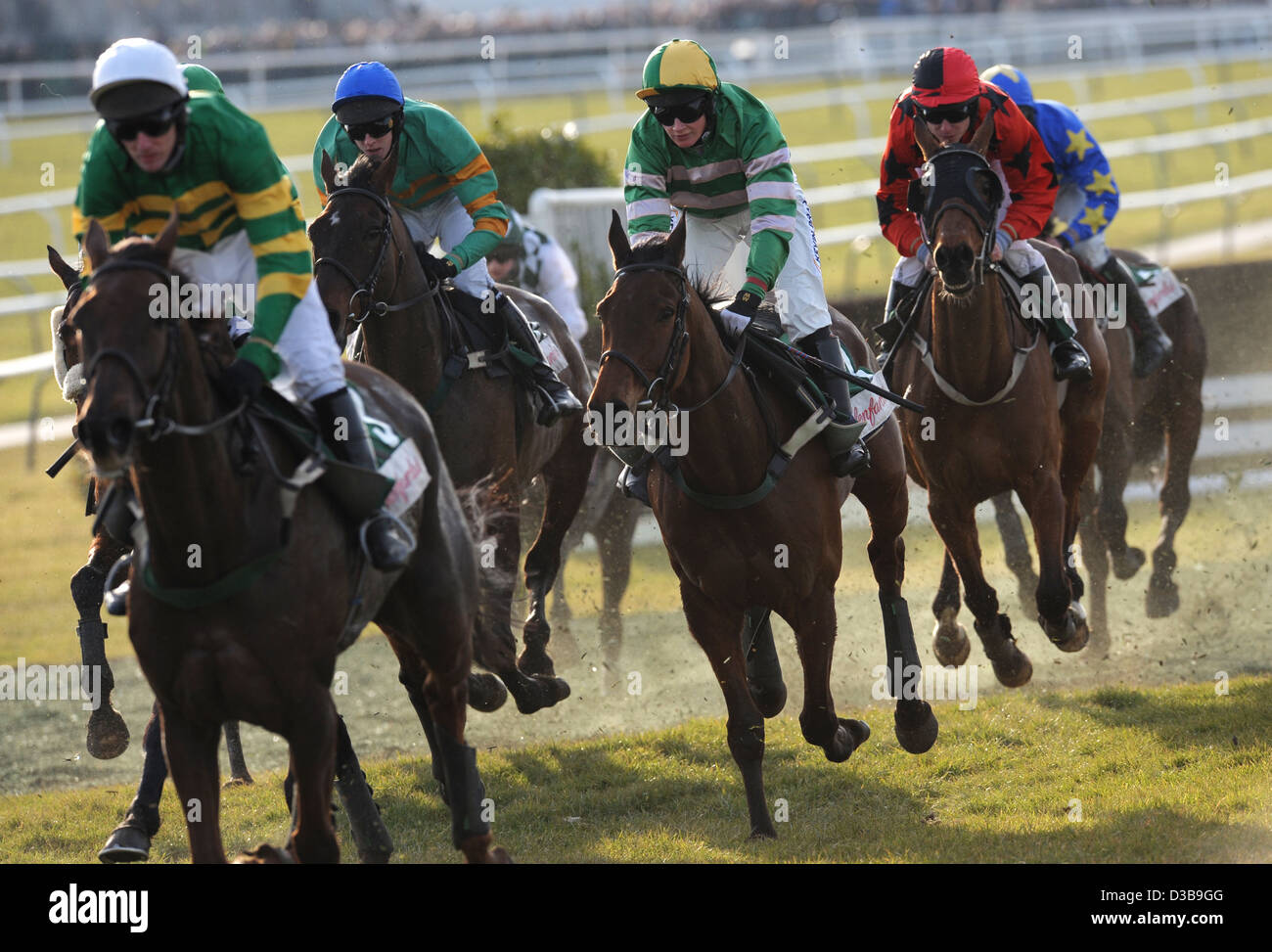 Jockeys jump their horses over a fence during The Cheltenham Festival ...